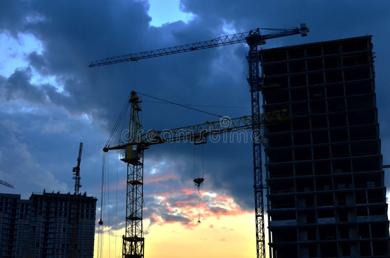 Tower Cranes at Construction Site in the Sunset Sky Stock Image - Image ...