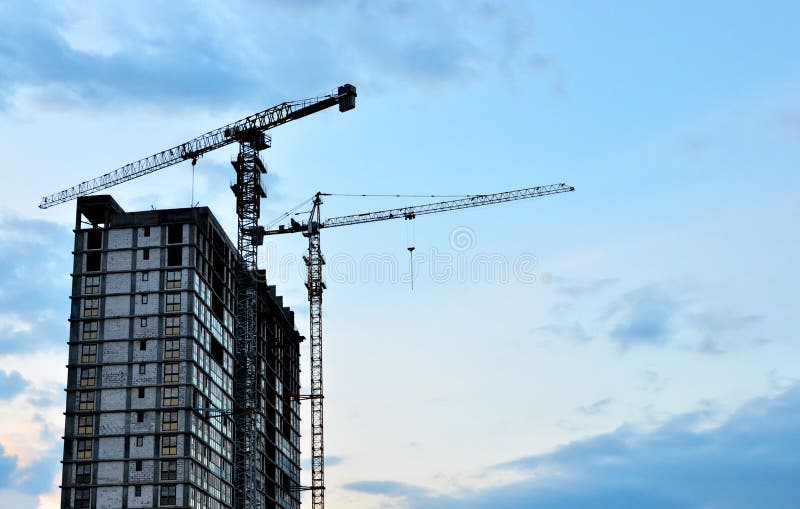 Tower Cranes at Construction Site in the Sunset Sky Stock Image - Image ...