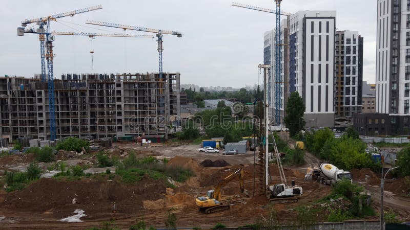 Tower Cranes and Drilling Rig Constructing Apartment Complex Foundation ...