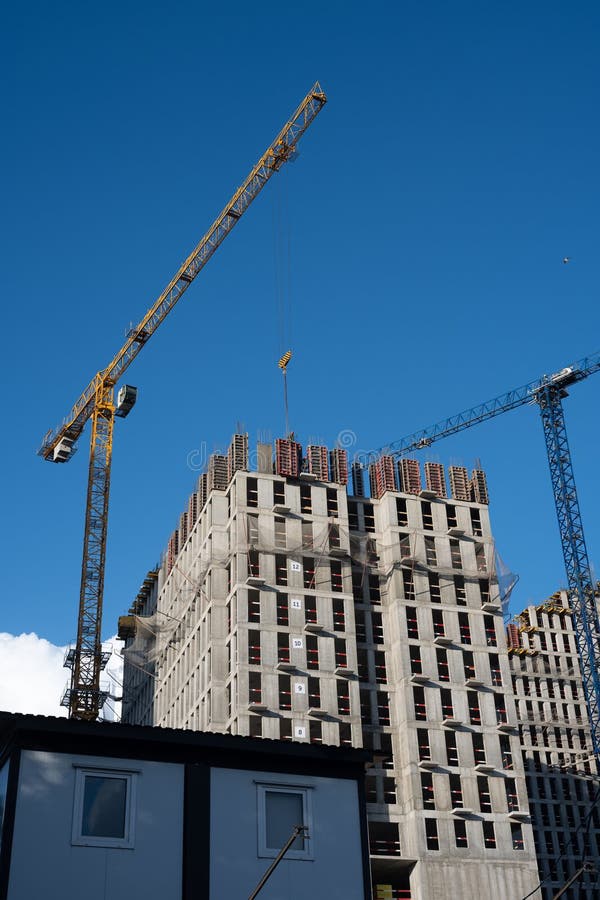 Construction Cranes Building New Apartment Building Under Blue Sky ...