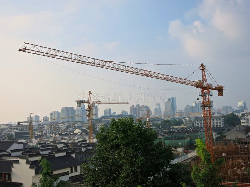 Tower cranes in action editorial photography. Image of constructing ...