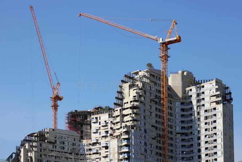 Tower Cranes Working on a High Rise Building Under Construction Stock ...