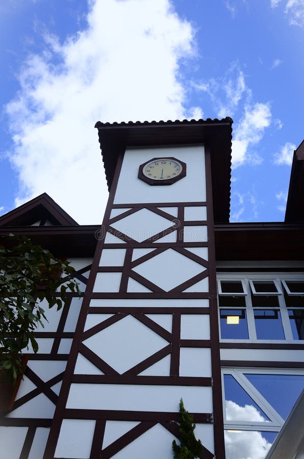 A Tower on the House with a Clock Showing 6:30 and the Blue Sky with ...