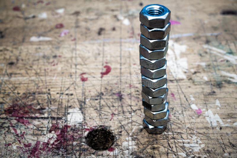 Tower Made from Assorted Metal Hex Nuts on Wooden Workbench Stained ...
