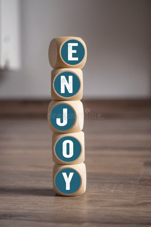 Tower Made of Cubes and Dice with Word Enjoy on Wooden Background Stock ...