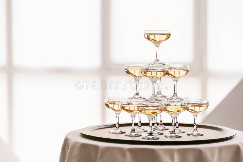 Tower Made of Glasses with Champagne on Table Indoors Stock Photo ...