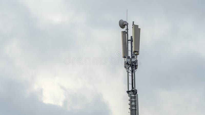 Tower with Mobile Operator Antennas on the Dramatic Sky Background ...