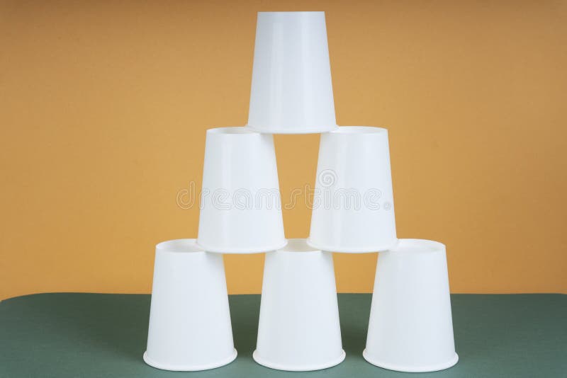 Tower of White Paper Cup. Cup Stacking Game on Green Table Stock Photo ...