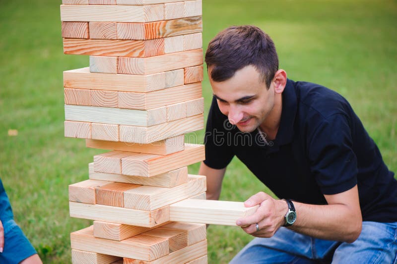 The Tower from Wooden Blocks. Group Game of Physical Skill with Big ...