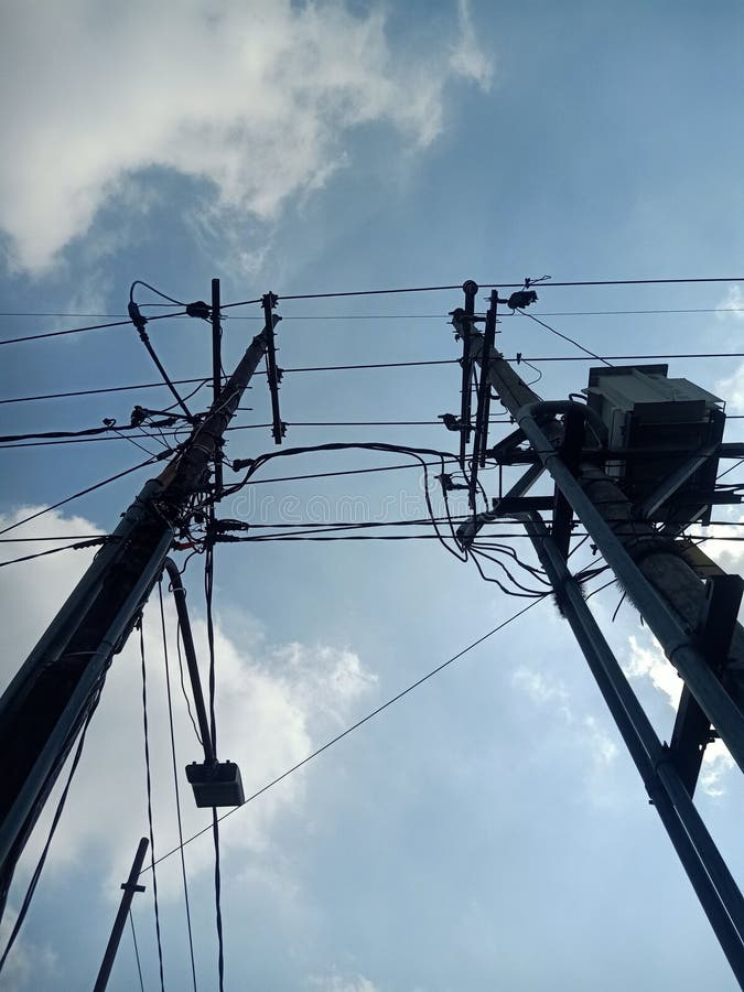 Towering Power Poles and Cables in Blue Clouds Stock Image - Image of ...