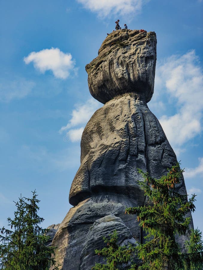 Towering Rock Formation with Climbers at the Summit Stock Photo - Image ...