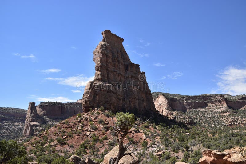 Towering Rock Formation Under a Blue Sky in Colorado National Monument ...