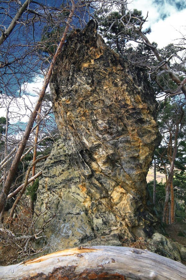 Towering Sandstone Spire Seen Close-up with Slanted Trees and Dramatic ...