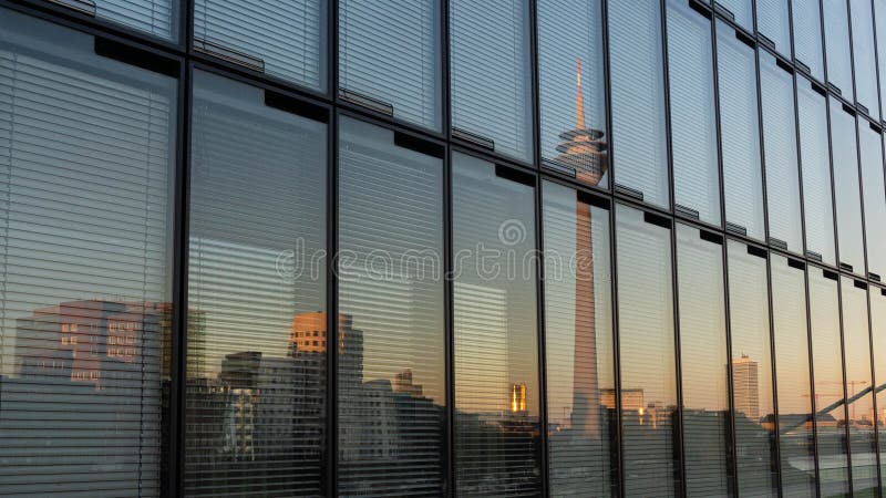 A Towering Structure is Reflected in the Shiny Windows of a Building ...