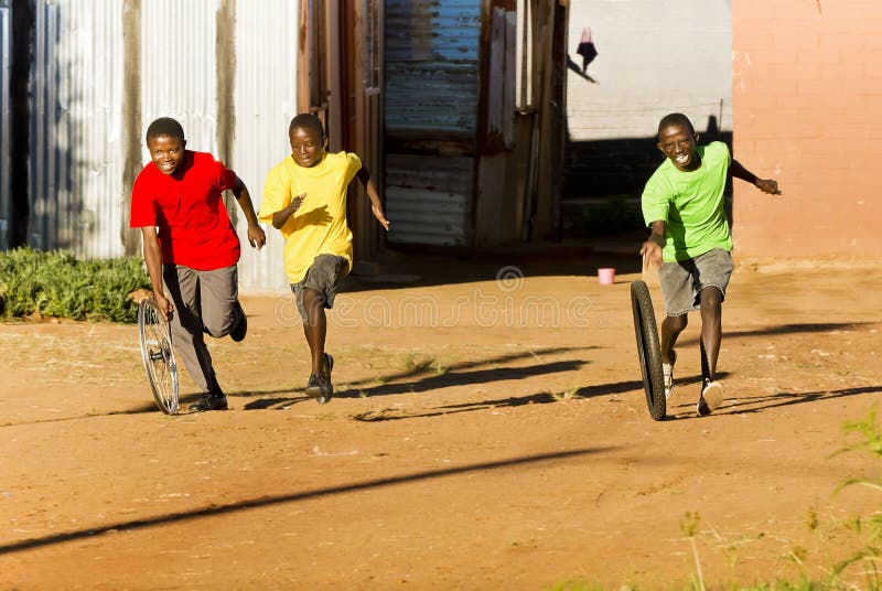 Teenage Boy Playing with Tyre - Yellow T-Shirt Stock Image - Image of ...