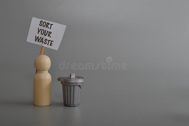 Toy Dustbin and Wooden Figure with Text SORT YOUR WASTE Stock Photo ...