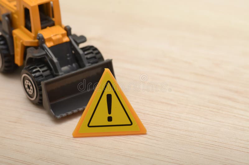 Toy Excavator and Warning Sign: Emphasizing Safety in Construction ...