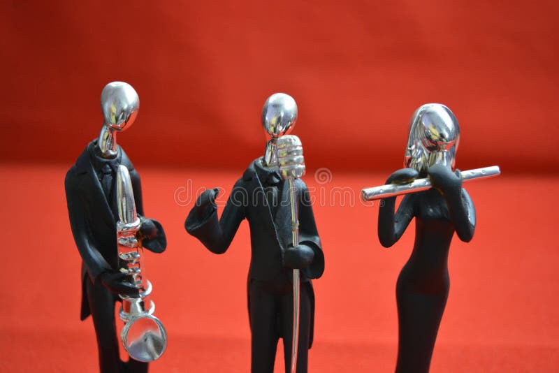 Toy Man with Microphone and Musicians on Red Background. Stock Photo ...