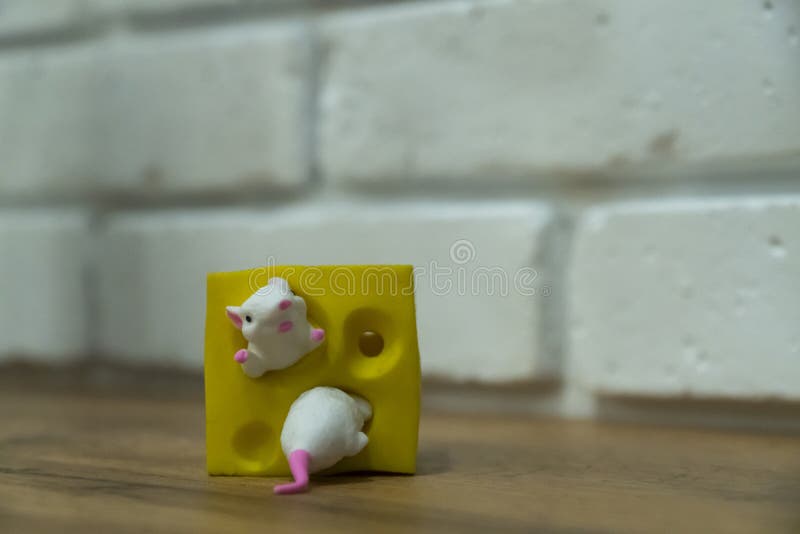 Toy Mice and Cheese. Rats Crawl Over a Piece of Cheese Stock Image ...