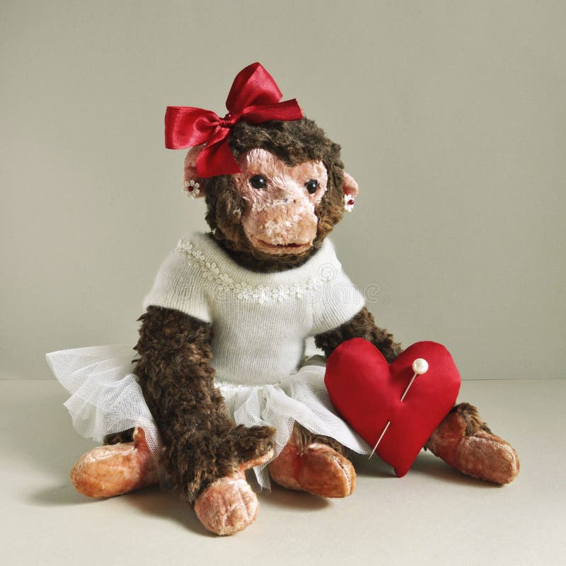 Toy monkey with red heart stock photo. Image of braid - 62702402