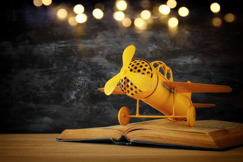 Toy Plane and the Open Book on Wooden Table. Stock Image - Image of ...