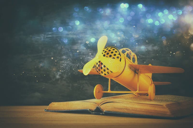 Toy Plane and the Open Book on Wooden Table. Stock Photo - Image of ...