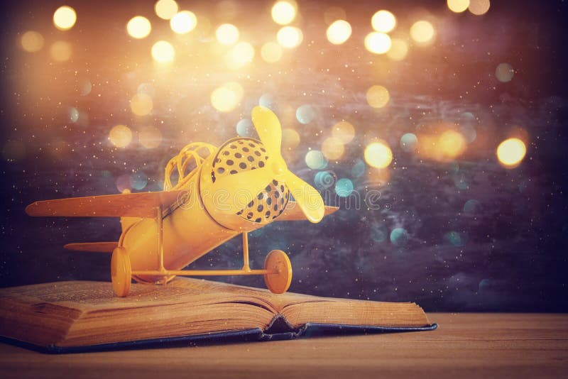 Toy Plane and the Open Book on Wooden Table. Stock Photo - Image of ...