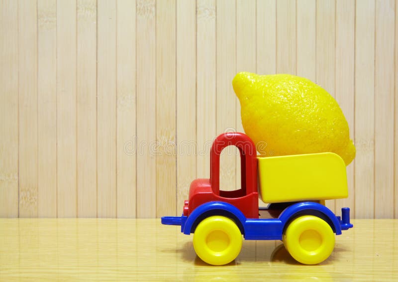 Toy Plastic Car with Yellow Lemon Stock Photo - Image of organic ...