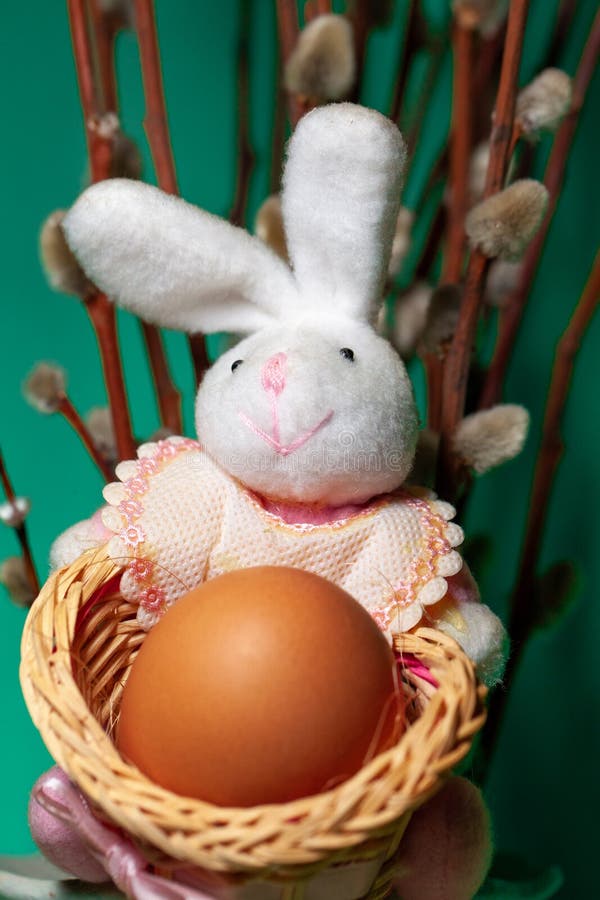 Toy Rabbit Holds a Chicken Egg in a Basket. Easter Bunny with Egg Stock ...