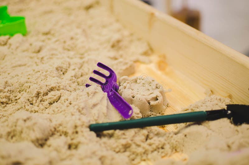 Toy Spade and Rake in a Children`s Sandbox Stock Photo - Image of ...