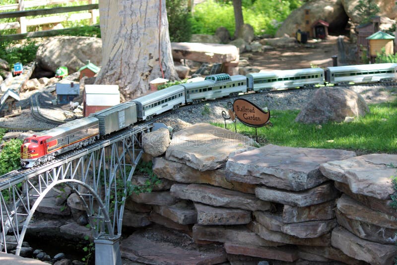 Toy Train through Garden editorial stock photo. Image of bridge - 74315103