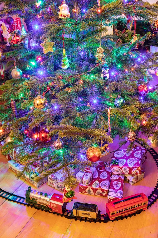 A Toy Train and Presents Under a Christmas Tree Stock Image - Image of ...