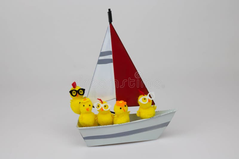 Toy Yellow Chickens are Sitting in a Toy Boat with Sails. the Concept ...