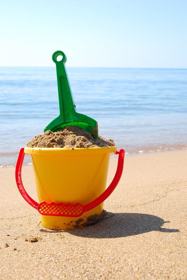 Red Bucket and Blue Spade on Sunny Sandy Beach Stock Photo - Image of ...