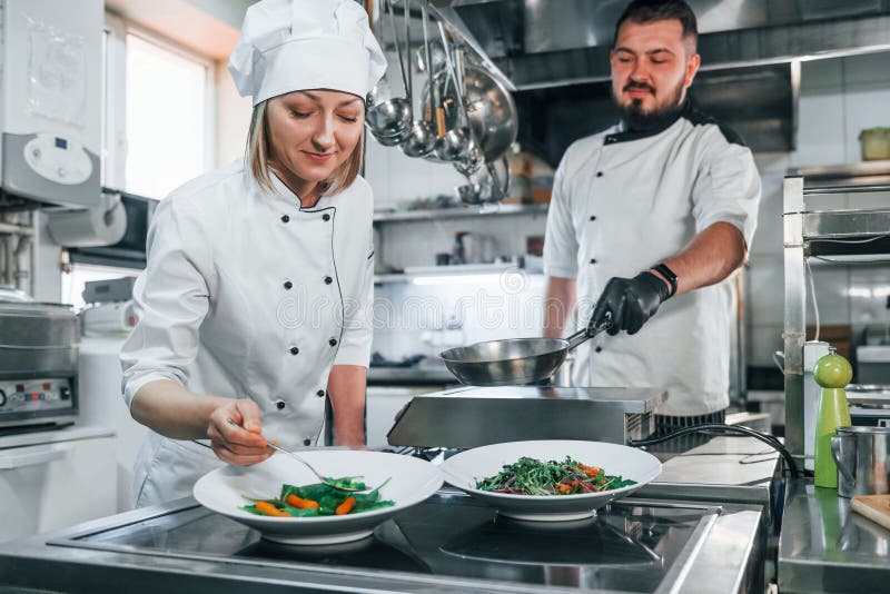 Trabajar Juntos. Chef Profesional Que Prepara Comida En La Cocina ...