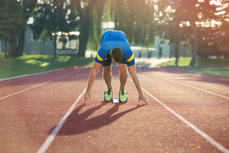 Track Runner in Starting Position on Sunny Morning. Stock Image - Image ...