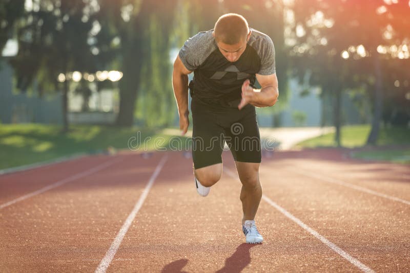 Track Runner in Starting Position on Sunny Morning. Stock Photo - Image ...