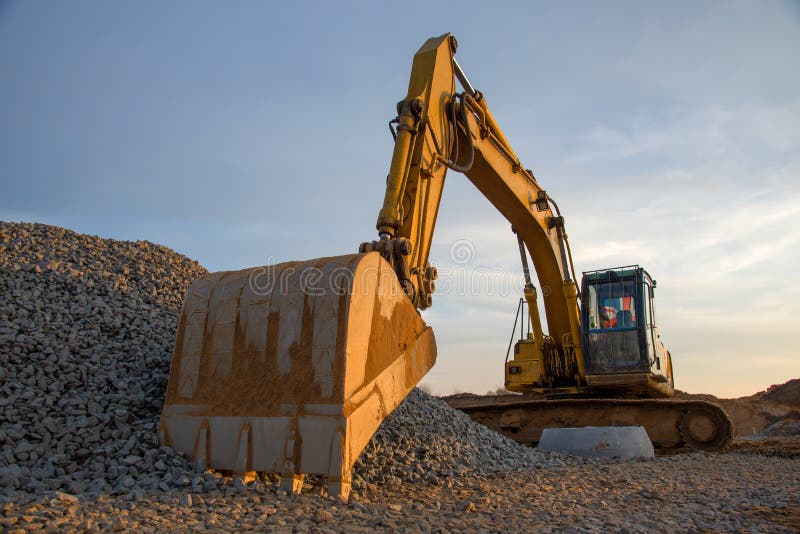 Track-type Excavator during Earthmoving Work at Open-pit Mining. Loader ...