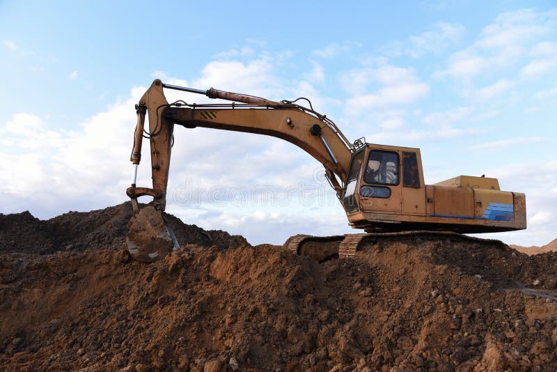 Track-type Excavator during Earthmoving Work at Open-pit Mining. Loader ...