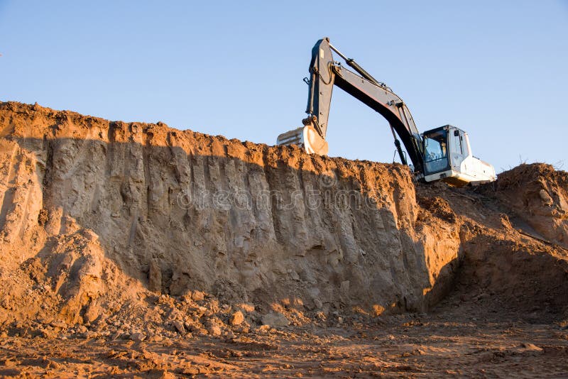 Track-type Excavator during Earthmoving Work at Open-pit Mining. Loader ...