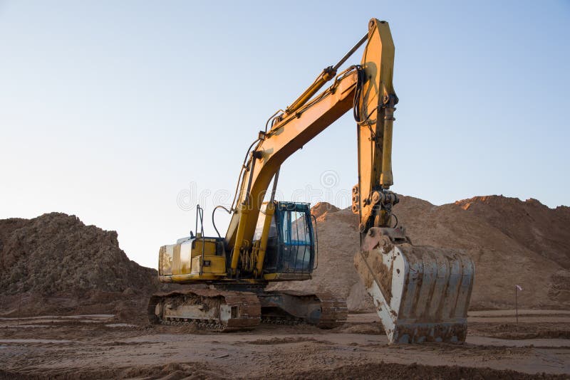 Track-type Excavator during Earthmoving Work at Open-pit Mining. Loader ...
