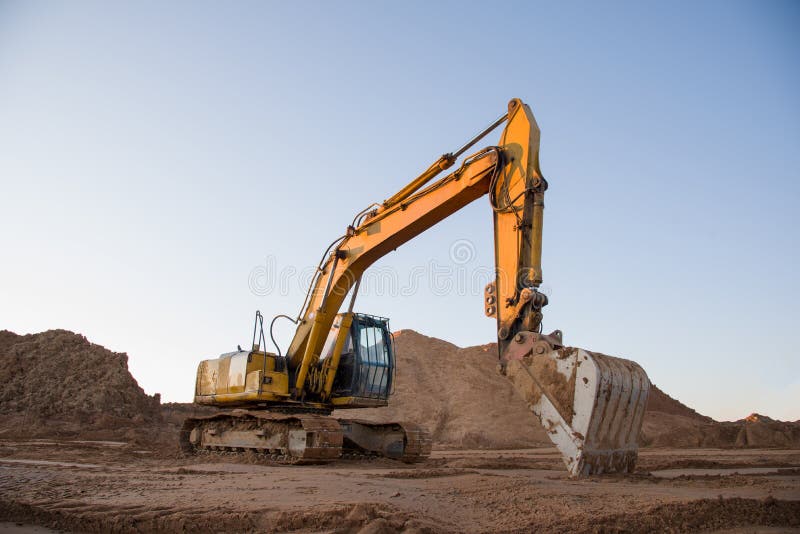 Track-type Excavator during Earthmoving Work at Open-pit Mining. Loader ...