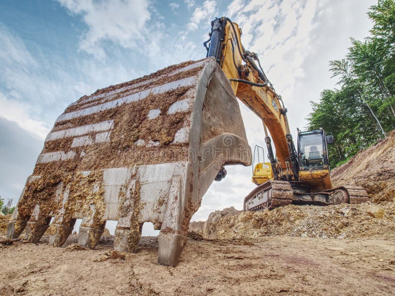 Track Type Loader is Mining Stones in Opencast Mining Quarry. Heavy ...