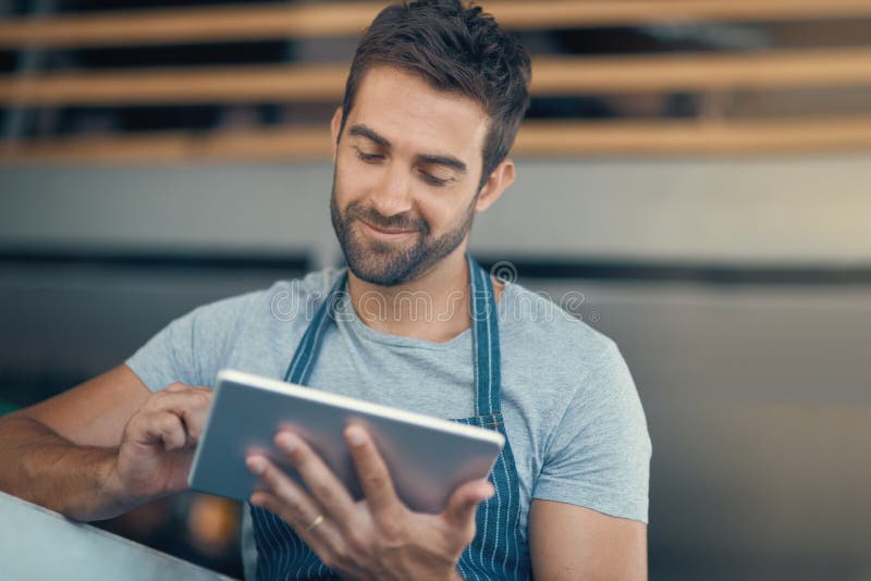 Tracking Coffee Shop Operations on His Tablet. a Young Man Using a ...