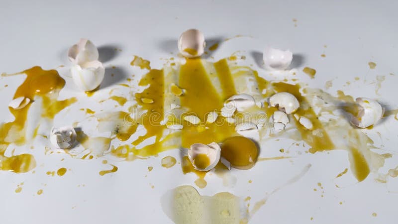 Tracking Shot Reveals Messy Broken Eggs and Shells on White Background ...