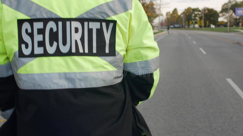 Tracking Shot of Security Guard in Uniform Patrolling Commercial Area ...