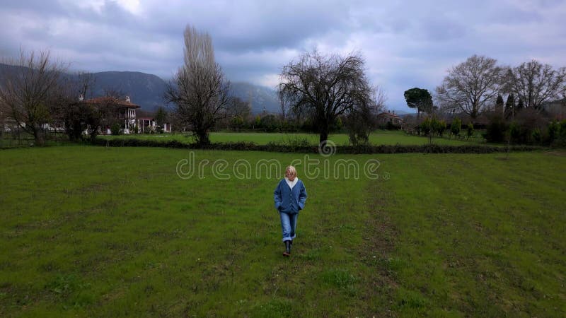 Tracking Shot of a Woman Walking in the Green Fields Stock Footage ...