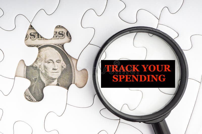 TRACKING YOUR SPENDING Text with Dollar Banknotes on White Jigsaw ...