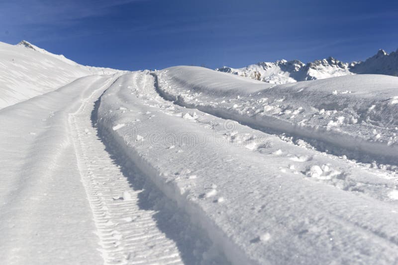 Tracks on a Road Covering with Fresh Snow Stock Photo - Image of white ...