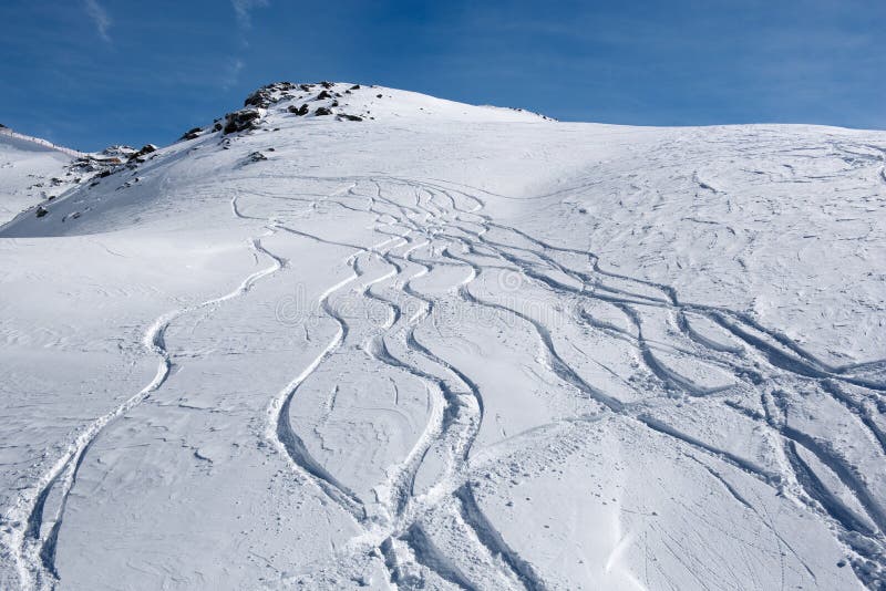 Tracks Running Down in the Snow on the Mountain Slopes Stock Photo ...